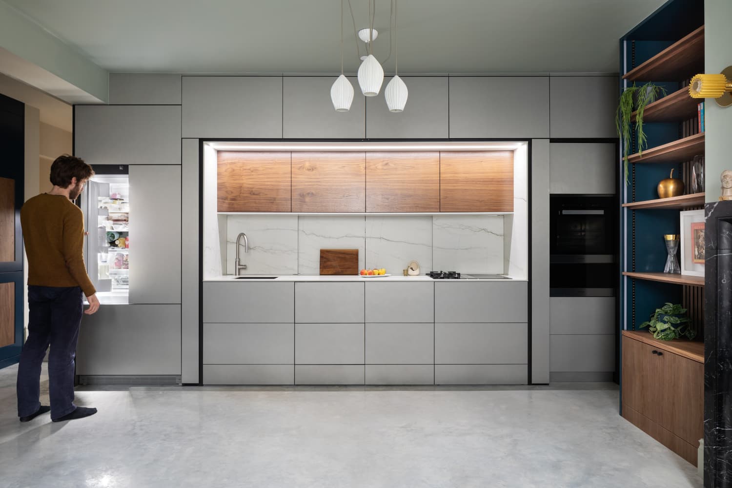A Wall of Minimalist Cabinets Keeps This Kitchen Hidden Away ...