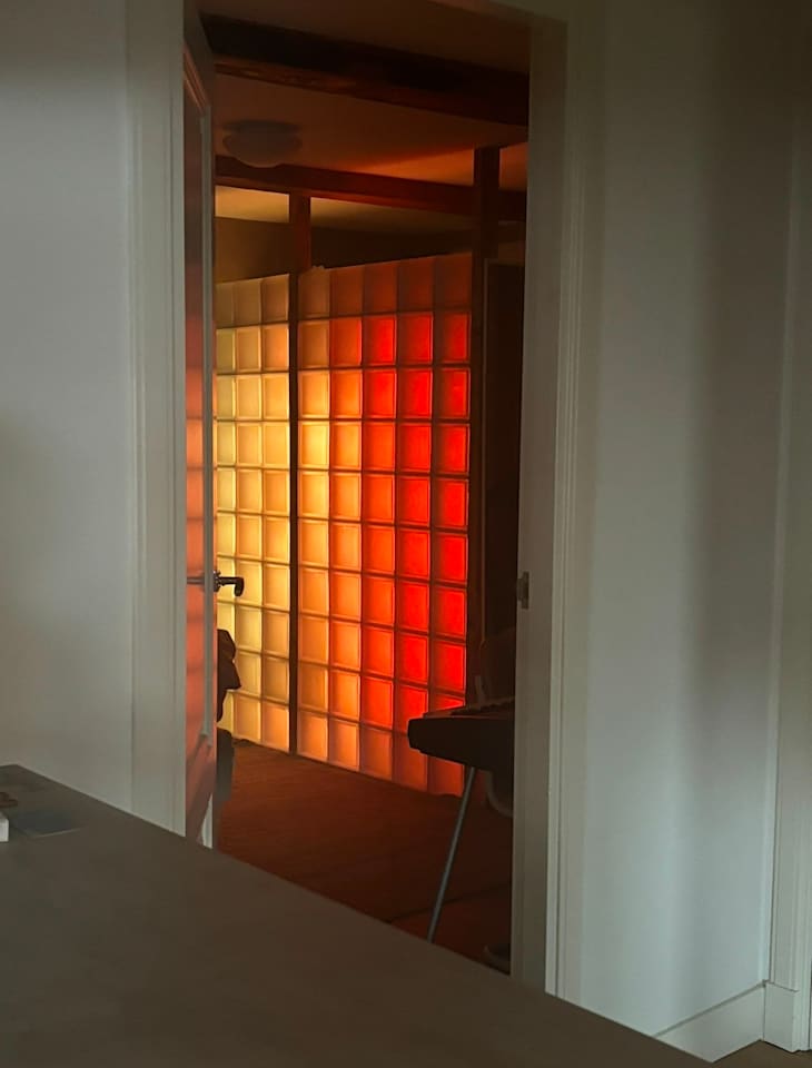 The Glass Brick Wall in This Bedroom Brightens the Space | Apartment ...