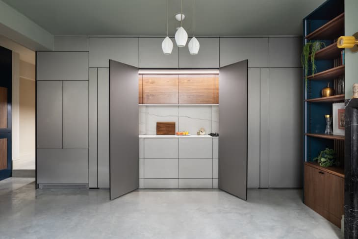 A Wall of Minimalist Cabinets Keeps This Kitchen Hidden Away ...
