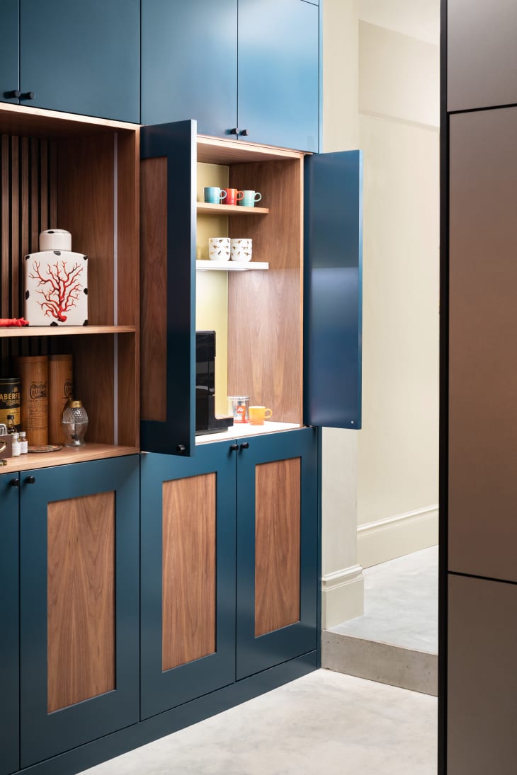 A Wall of Minimalist Cabinets Keeps This Kitchen Hidden Away ...