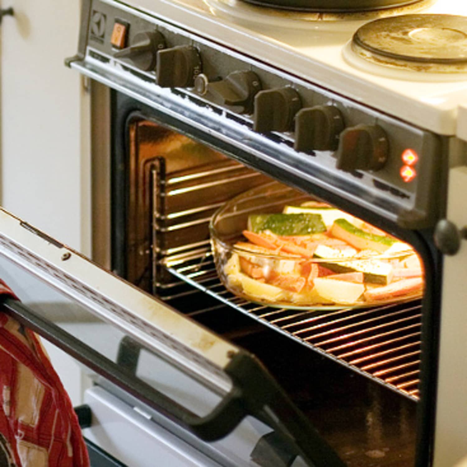 opening oven door while baking bread